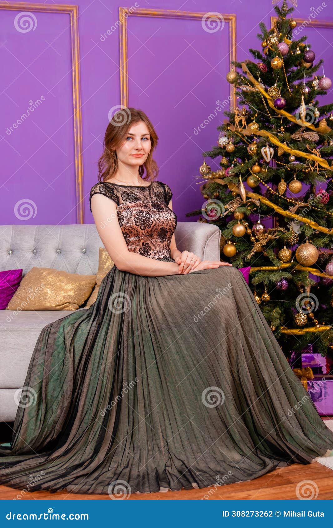 Portrait Of An Attractive Young Woman In A Green Dress Posing While