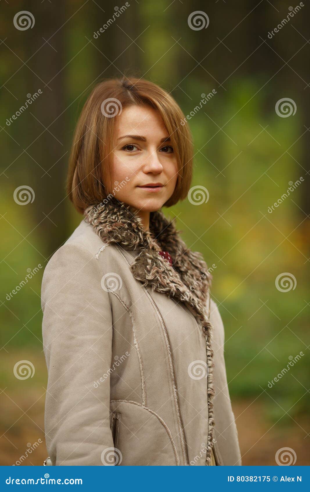 Portrait Of Attractive Young Woman In Warm Autumn Coat Outdoors Stock