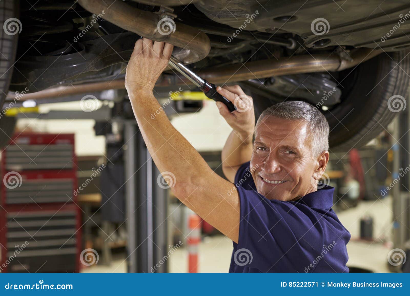Portrait of Auto Mechanic Working Underneath Car in Garage Stock Image ...