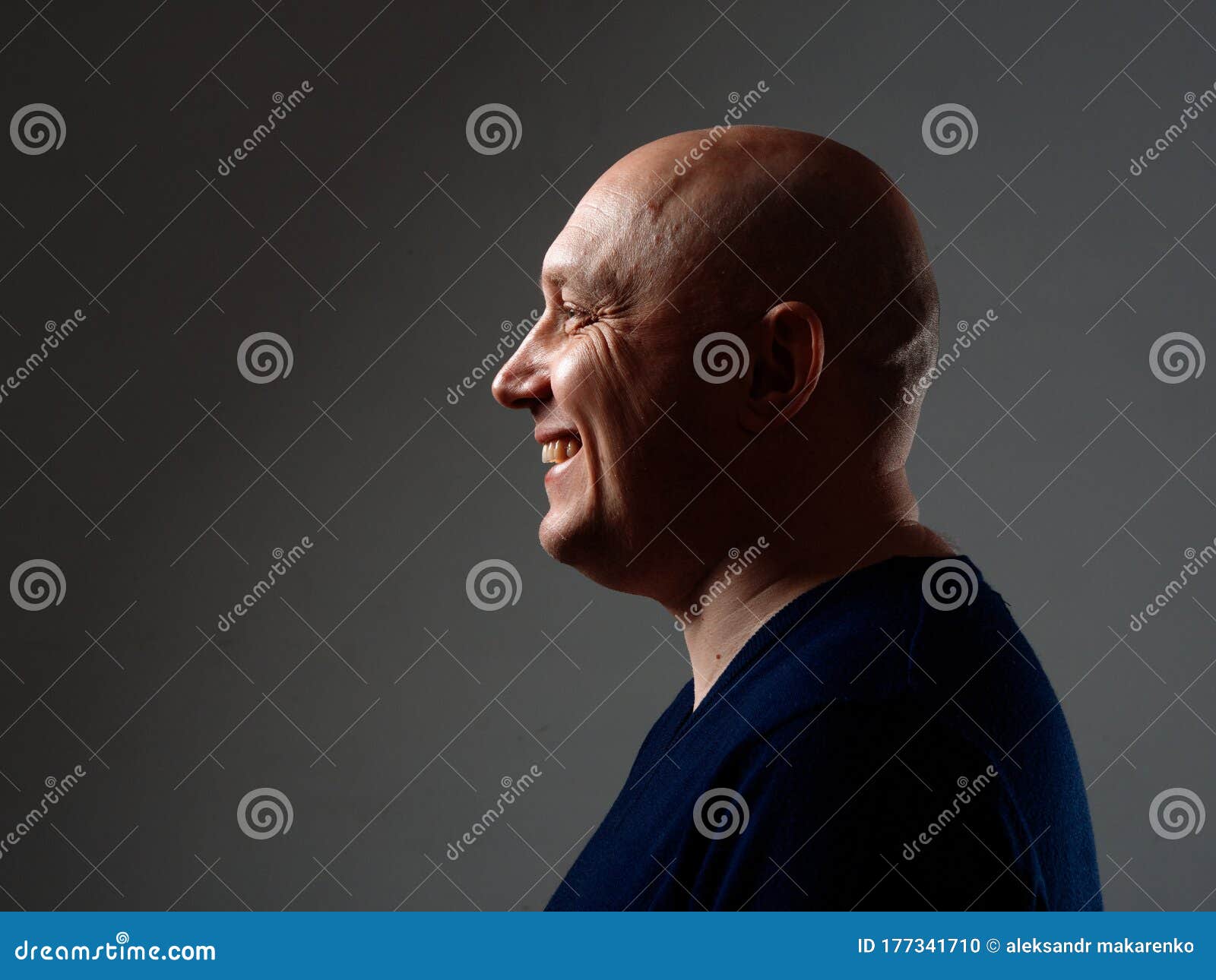 Portrait of a Bald Cheerful Man in Profile on a Black Background Stock ...