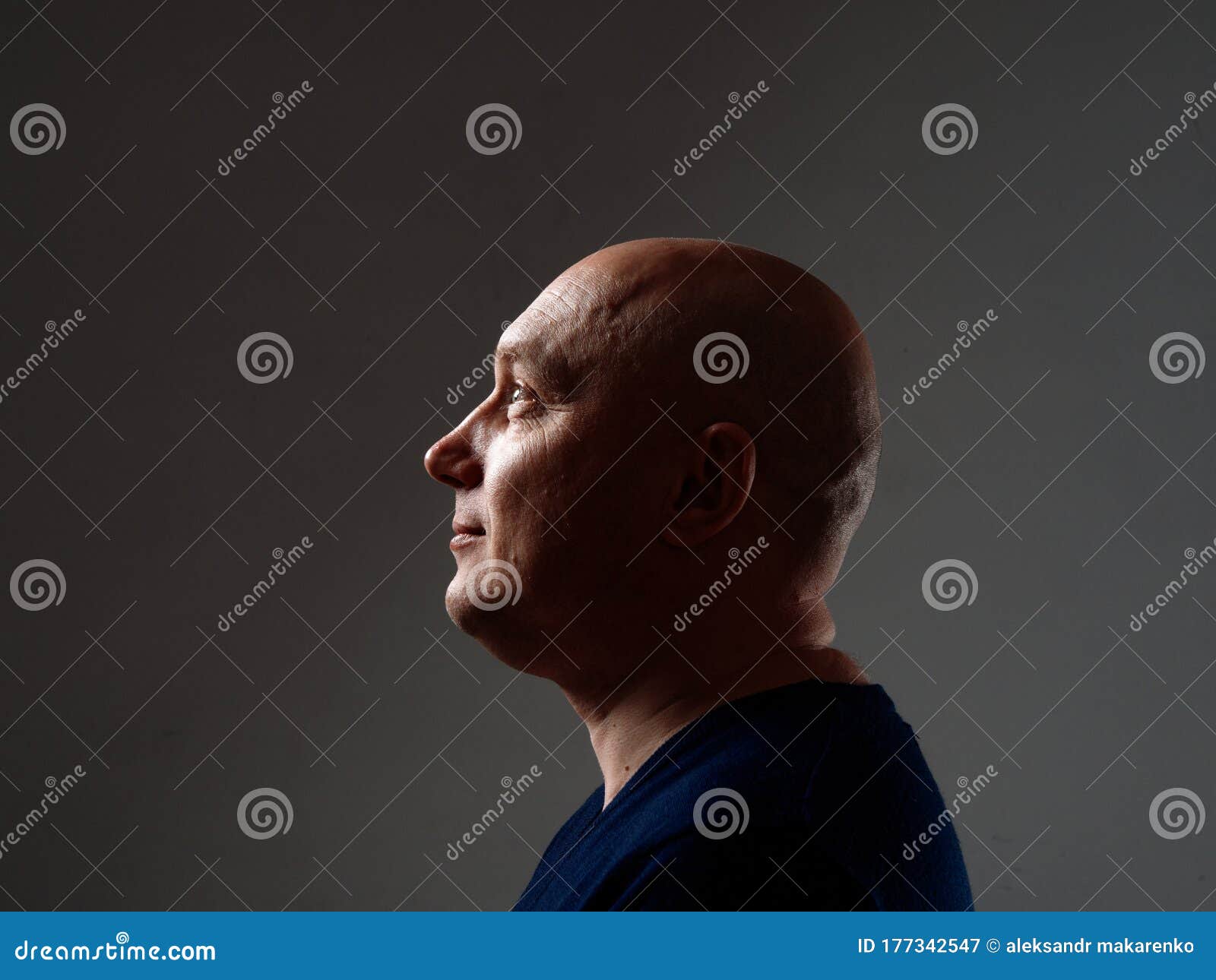 Portrait of a Bald Cheerful Man in Profile on a Black Background Stock ...