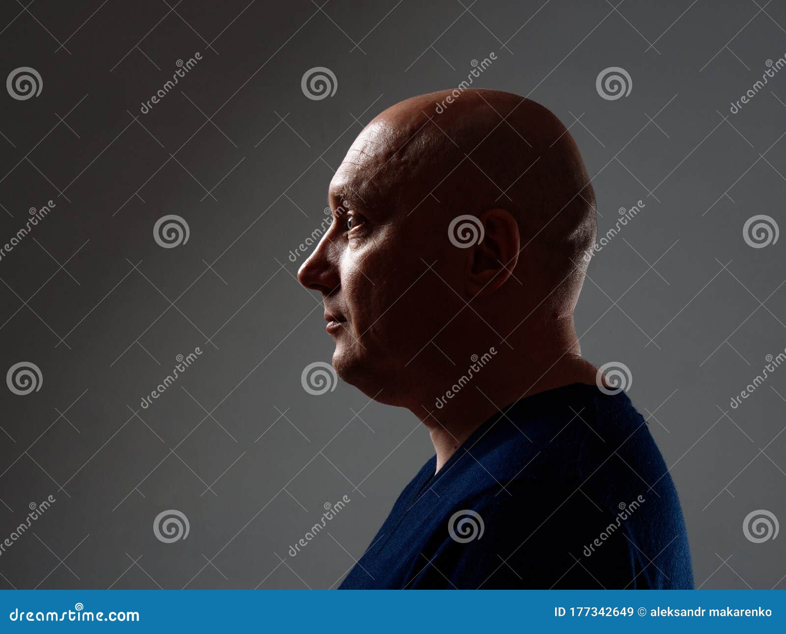 Portrait of a Bald Cheerful Man in Profile on a Black Background Stock ...