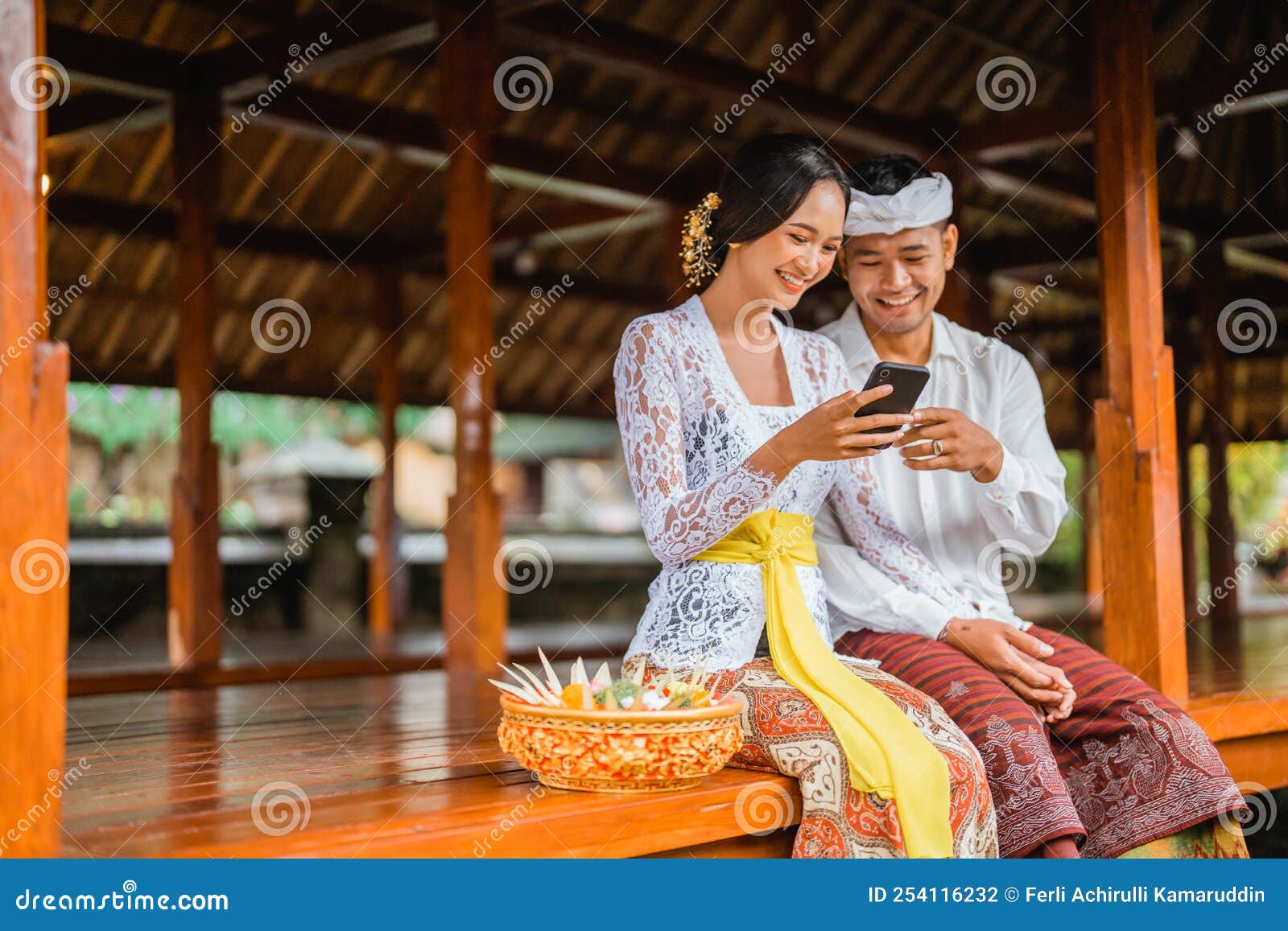 Portrait of Balinese Couple Using Mobile Phone Stock Photo - Image of ...