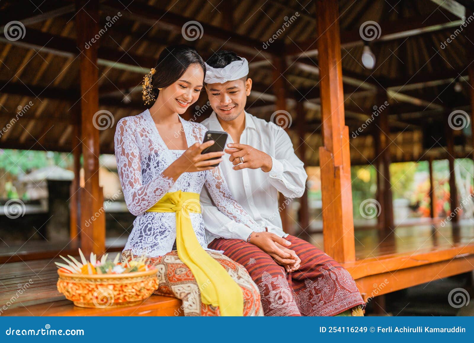 Portrait of Balinese Couple Using Mobile Phone Stock Image - Image of ...