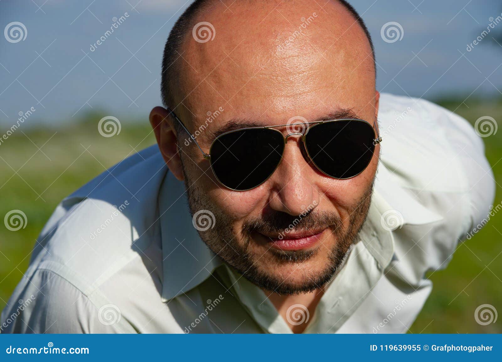 Portrait Of A Bearded Mature Man Wearing Sunglasses Against The Stock