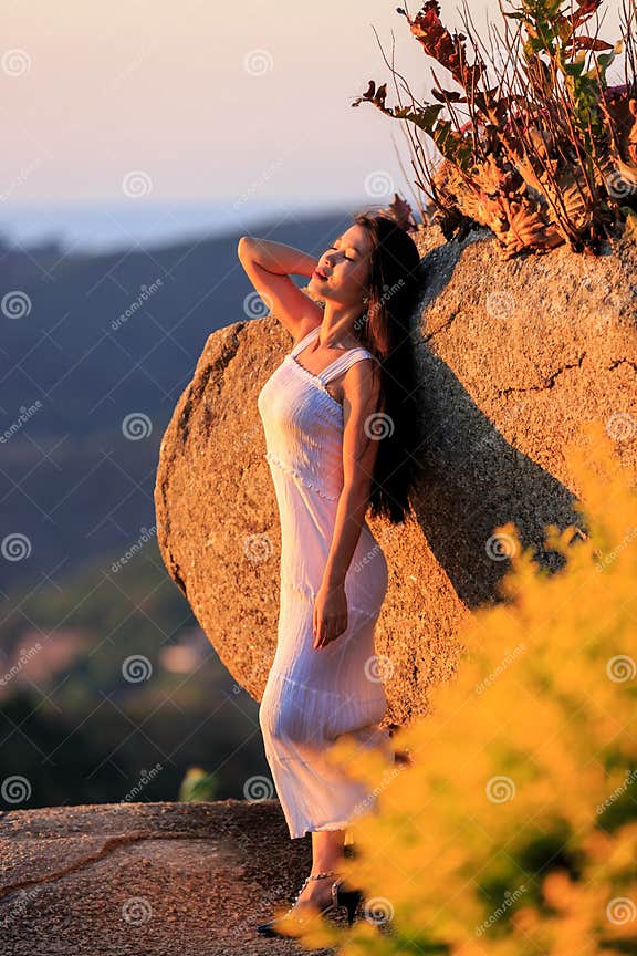 Portrait Of Beautiful Asian Girl In The White Dress At Sunset Stock