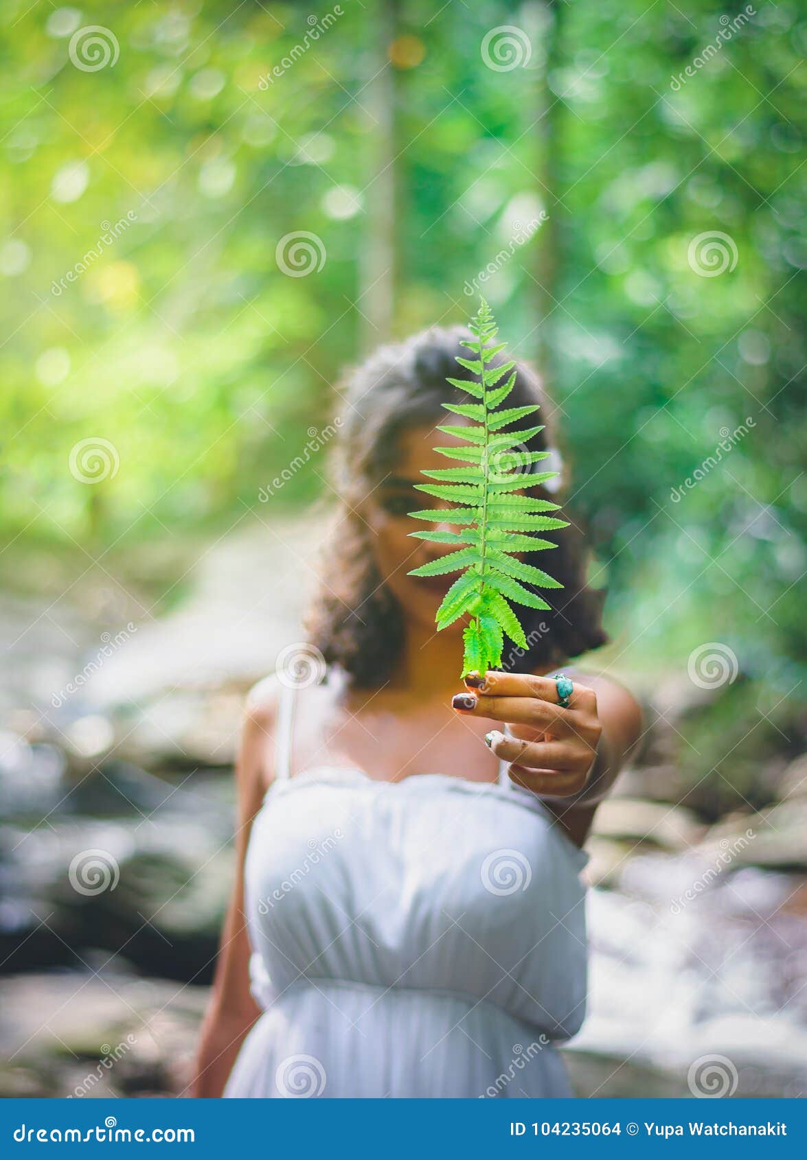 Portrait Of Beautiful Asian Woman Holding Green Leaf In Front Of Stock