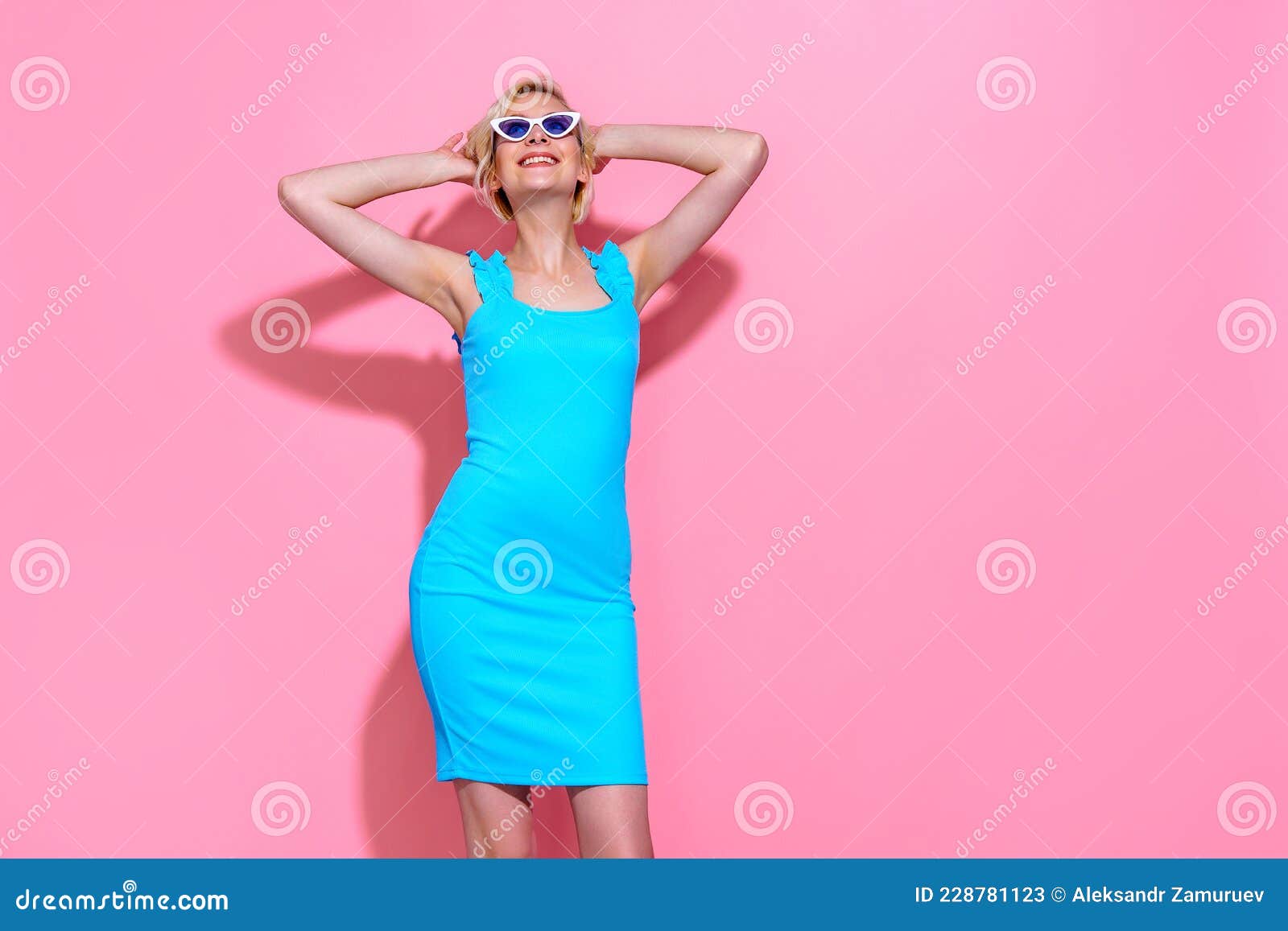 Portrait Of Beautiful Blonde Woman In Blue Dress With Sunglasses Posing