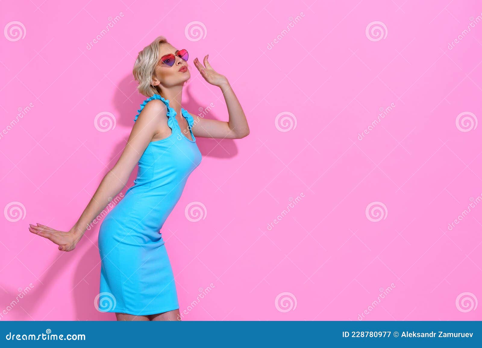 Portrait Of Beautiful Blonde Woman In Blue Dress With Sunglasses Posing