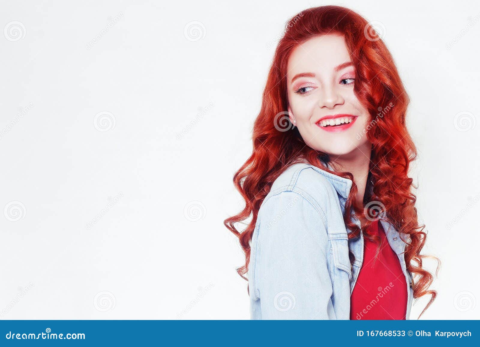 Portrait Of Beautiful Cheerful Redhead Girl With Flying Curly Hair