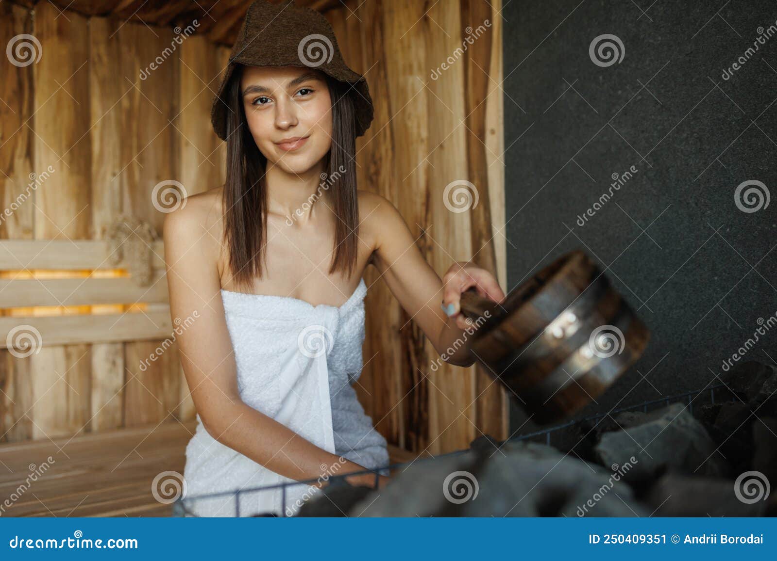 Portrait of a Beautiful Girl with a Wooden Ladle in the Sauna Pouring ... Portrait of a Beautiful Girl with a Wooden Ladle in the Sauna Pouring ...