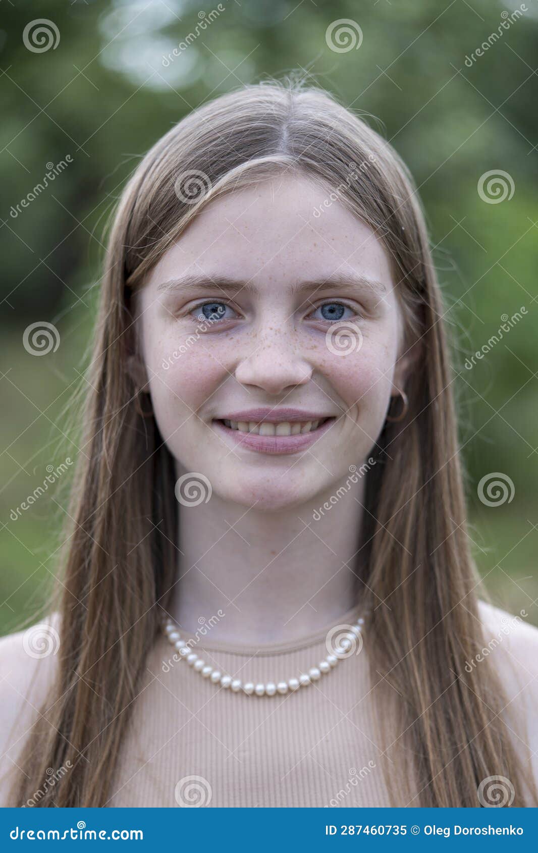 Portrait Of A Beautiful Happy Girl With Blond Hair And Freckles Looking