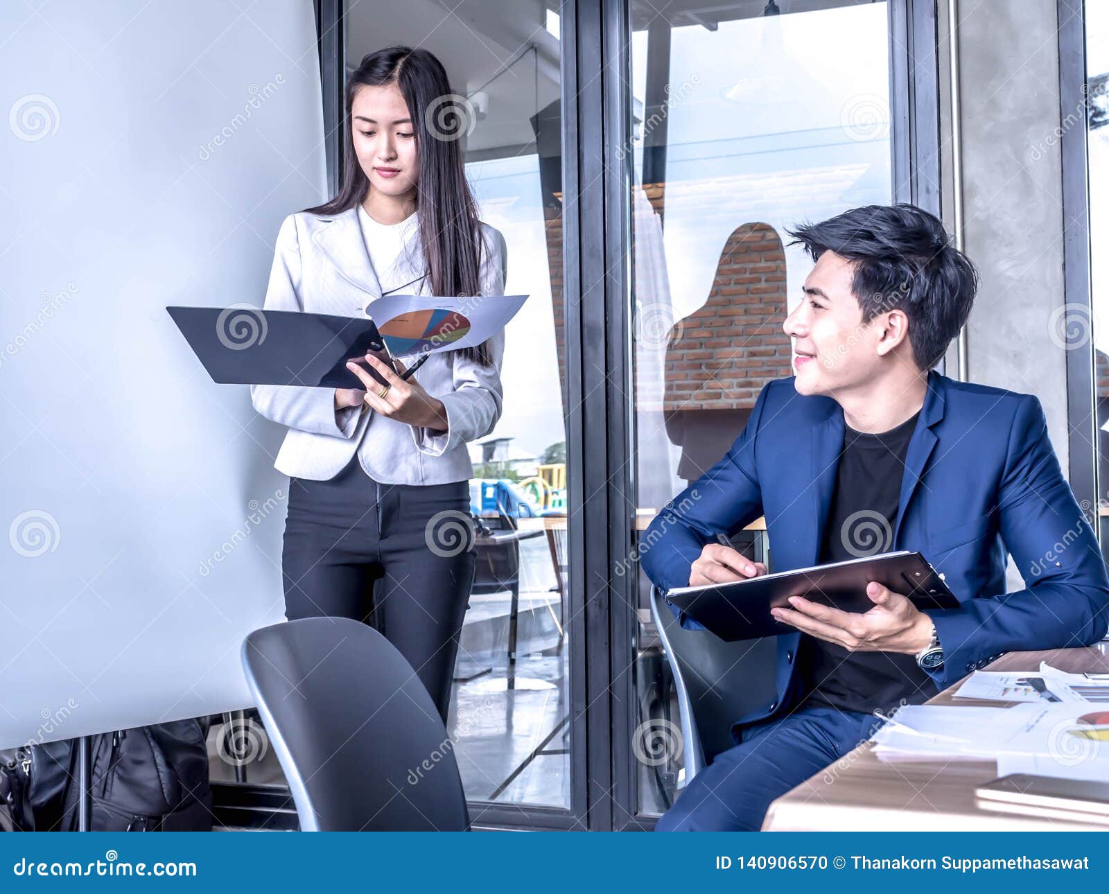 Portrait of Beautiful Intern Standing at Office in Front of Flip Chart ...