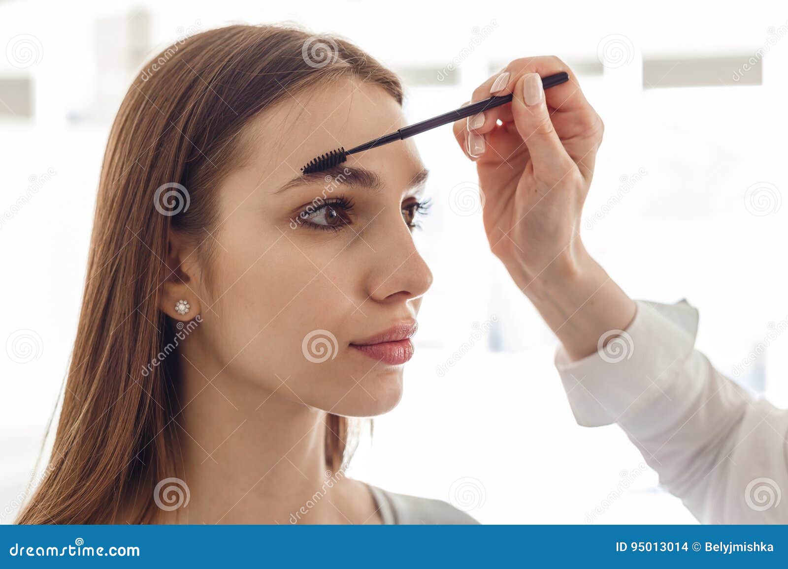 Portrait of a Beautiful Model during an Eyebrow Correction Procedure ...