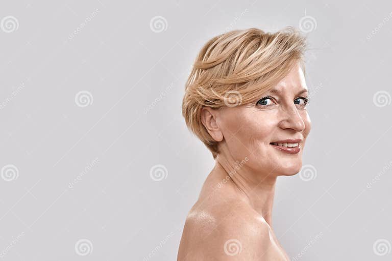 Portrait Of Beautiful Naked Middle Aged Woman Smiling At Camera While
