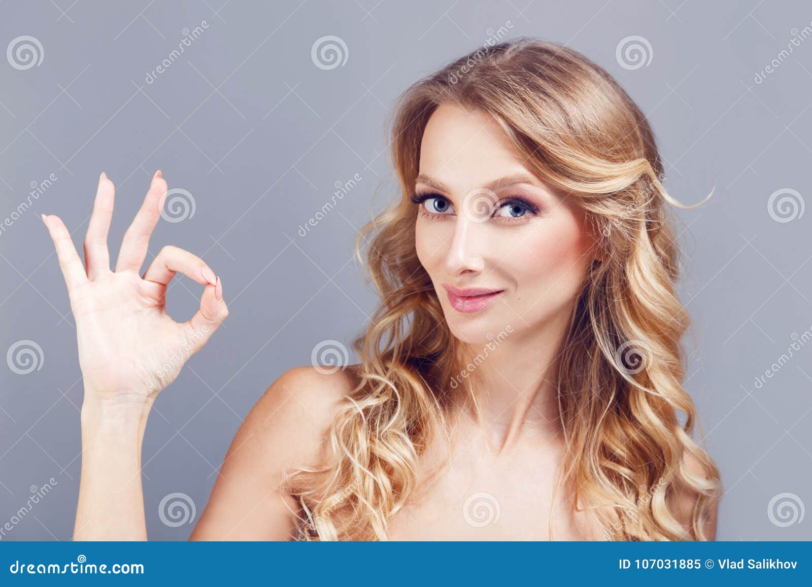 Portrait Of Beautiful Nlondhair Woman Showing Ok Gesture And Winking