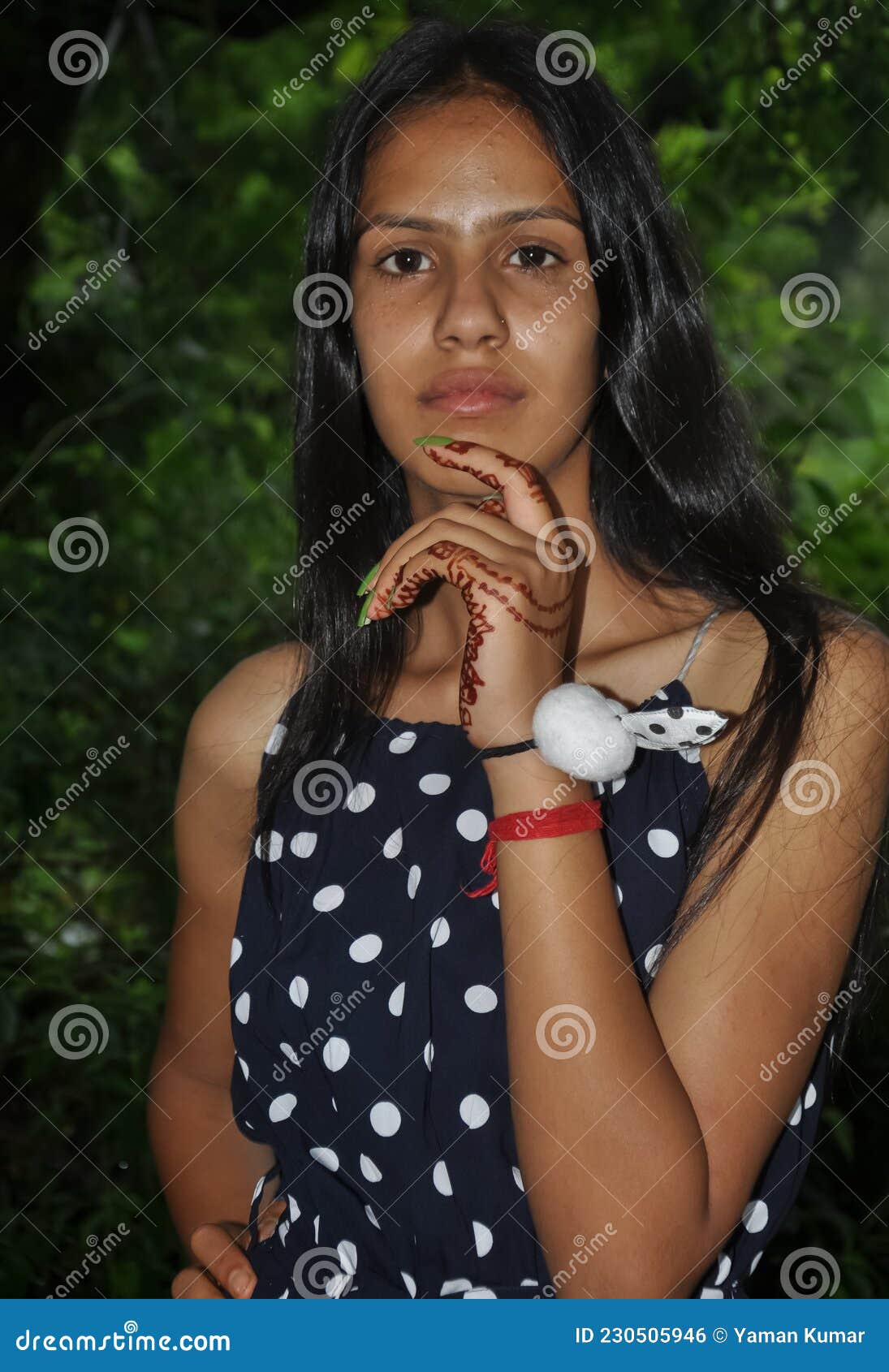 Portrait Of A Beautiful North Indian Young Girl Looking At The Camera And Posing With One Hand