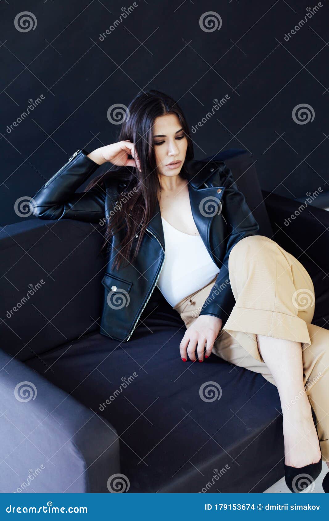 Portrait Of A Beautiful Oriental Fashionable Woman In A Black Leather