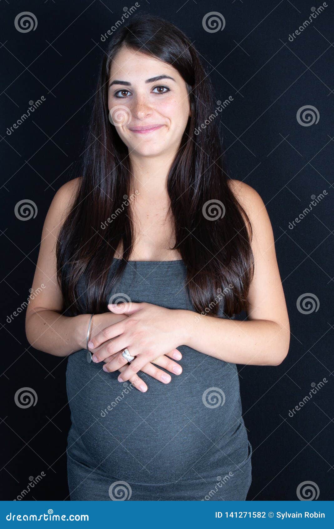 Portrait Of Beautiful Pregnant Woman On Black Background In Pregnancy