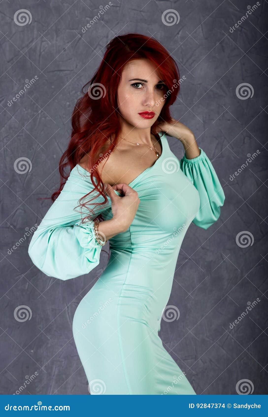 Portrait Of Beautiful Redhead Young Woman With Big Boobs In A Turquoise