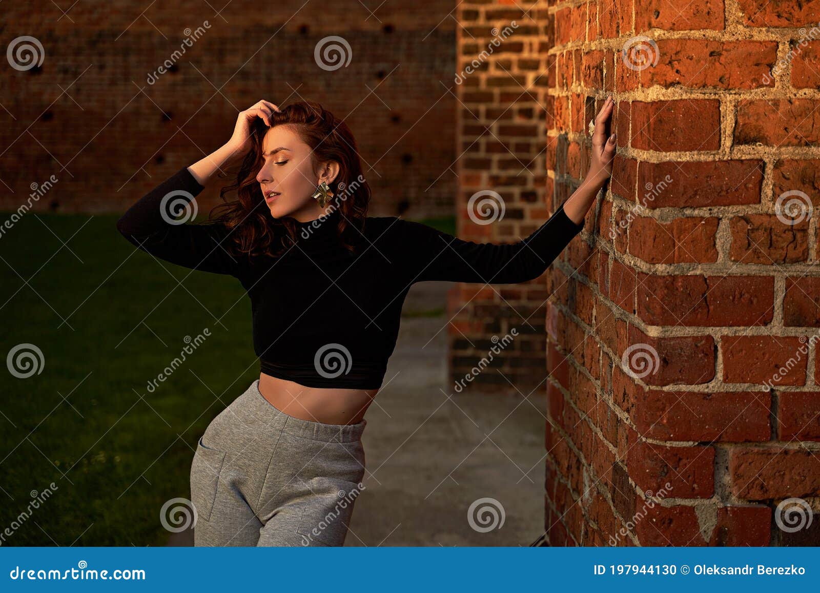 Portrait Of A Beautiful Sensual Redhead Girl Posing In Sunset Sunlight