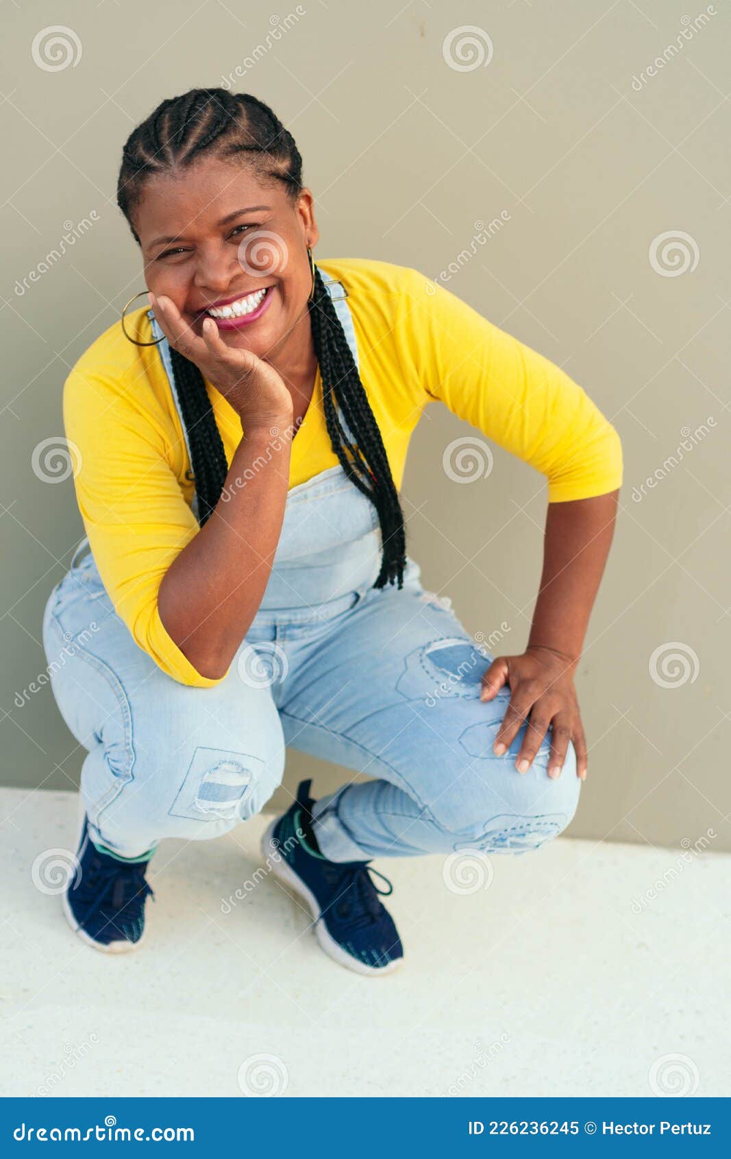 Portrait Of Beautiful Smiling African Woman Leaning Against The Wall