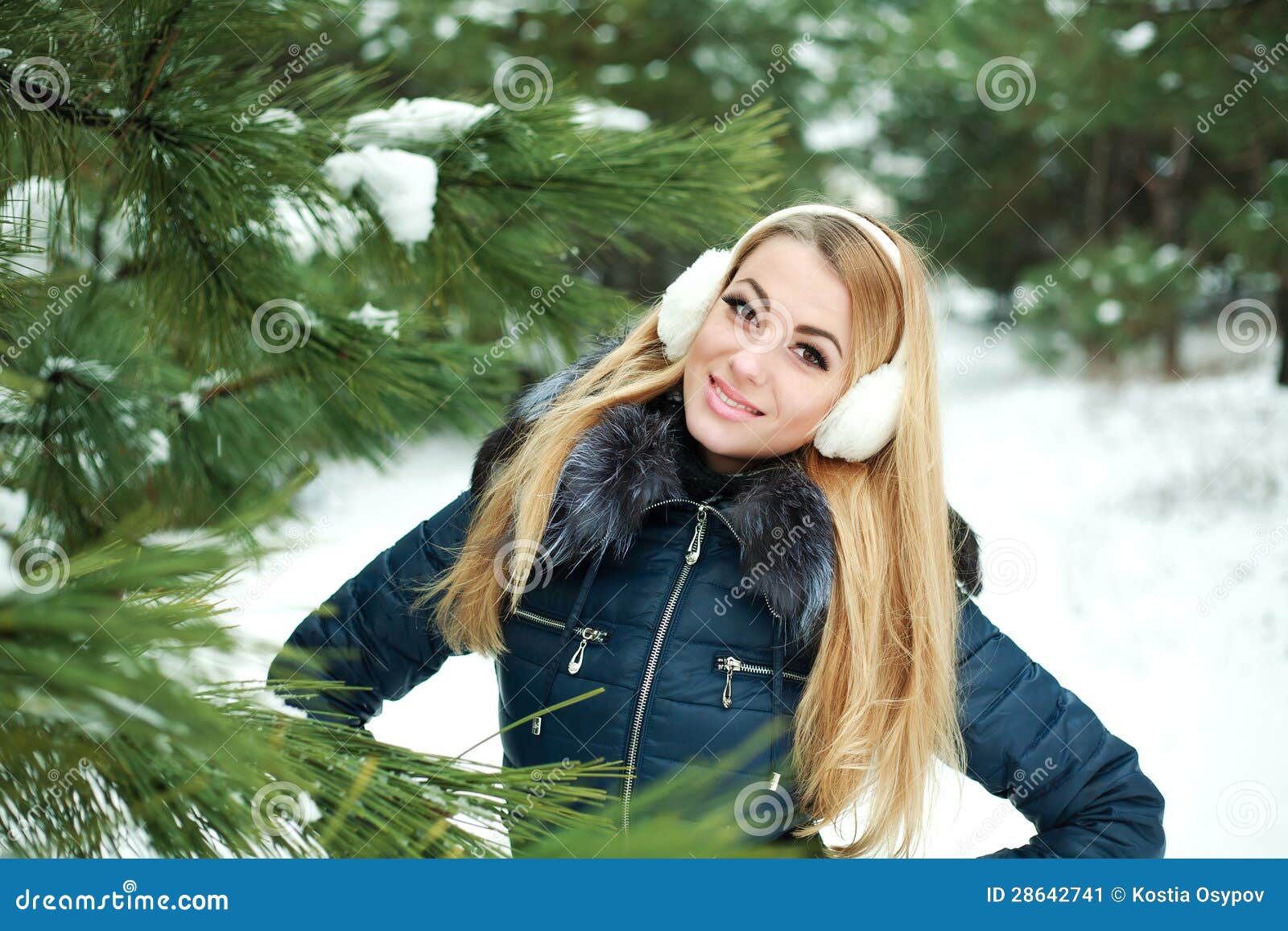 Portrait Of Beautiful Smiling Girl In Snowy Pinewood Stock Image