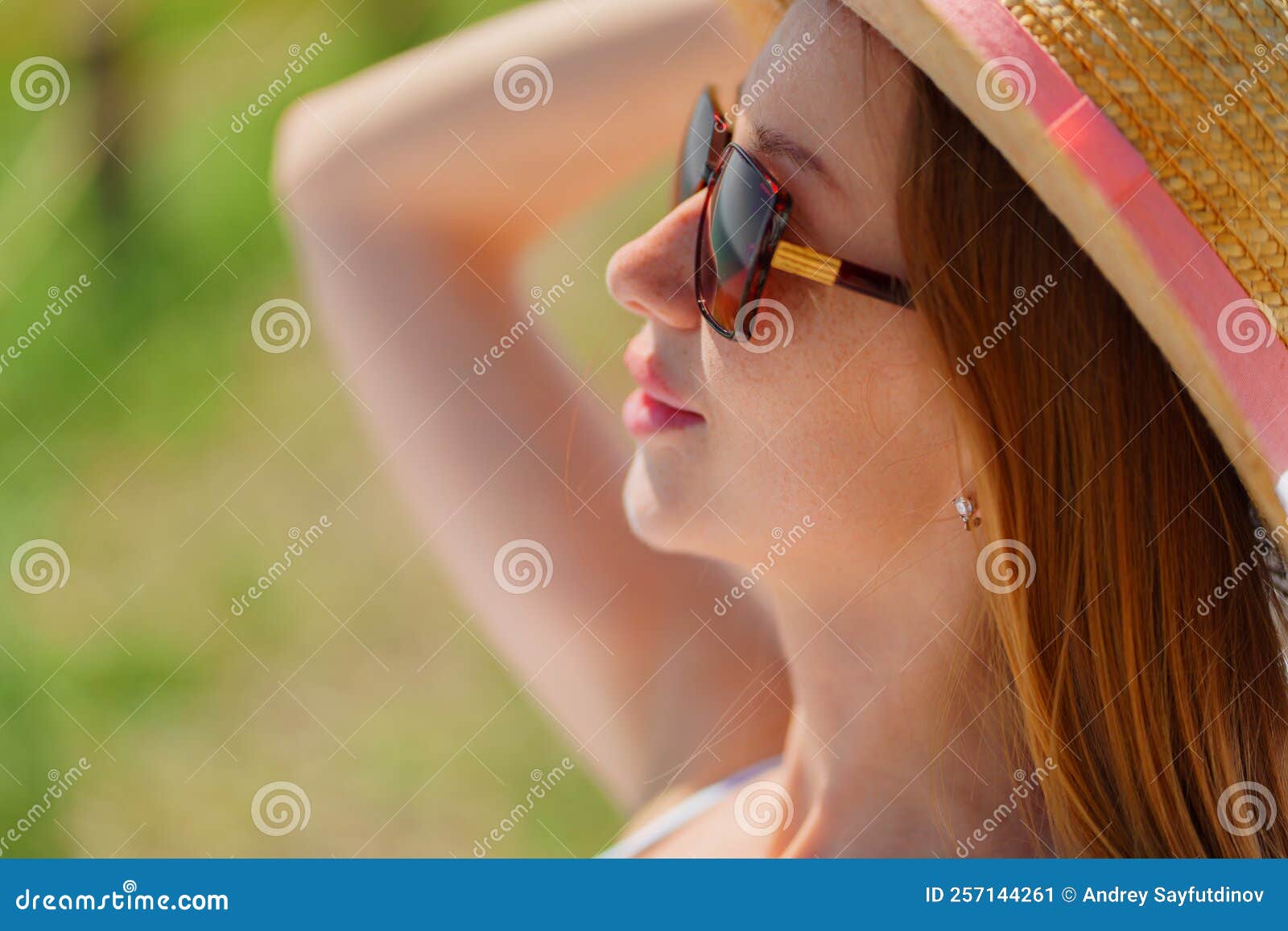Portrait Of A Beautiful Woman With Long Hair In A Straw Hat With