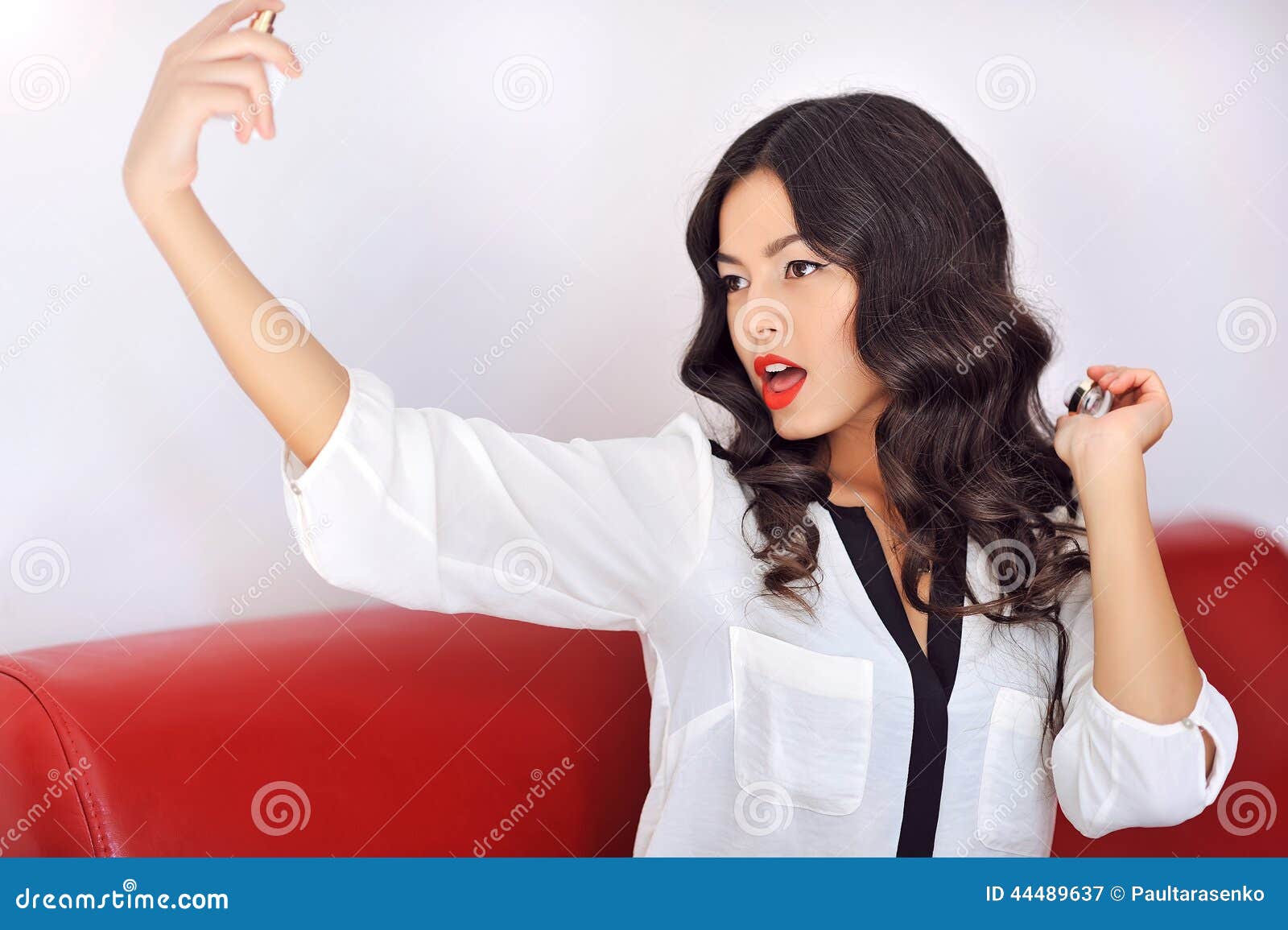Portrait of a Beautiful Woman Spraying Perfume Stock Image - Image of ...