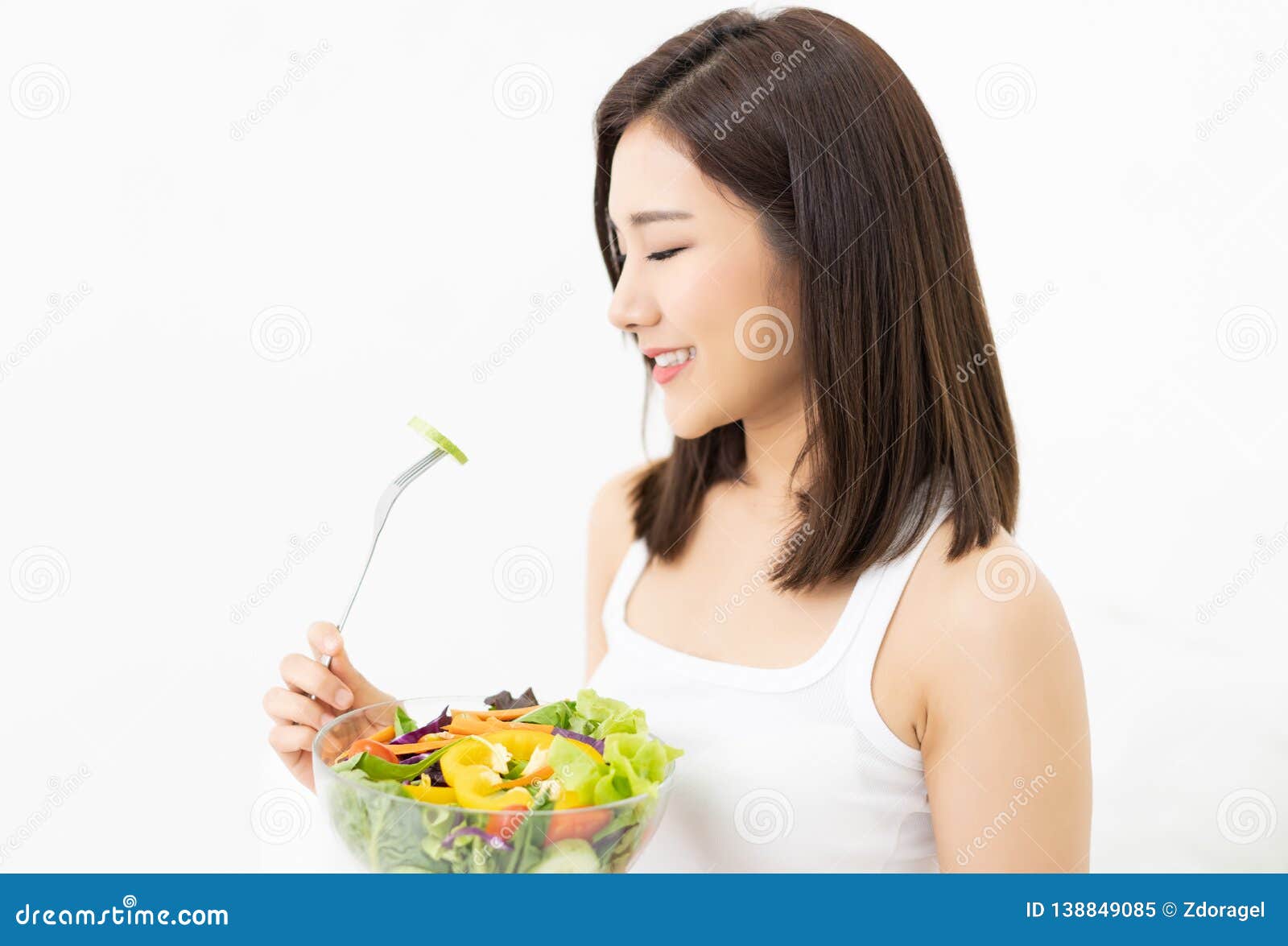 Portrait Of A Beautiful Young Asian Woman Eating Fresh Salad From A