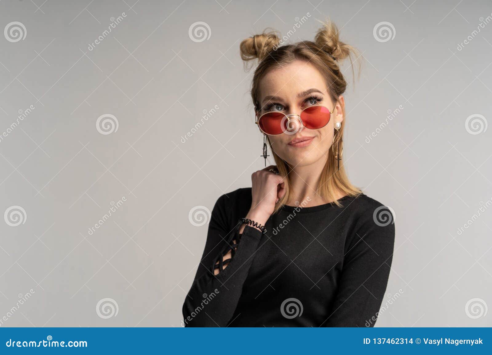 Portrait Of Beautiful Young Blonde Girl In Black Dress And Round