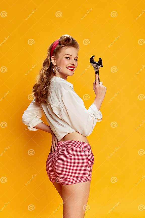 Portrait Of Beautiful Young Blonde Girl In White Shirt And Pink Shorts