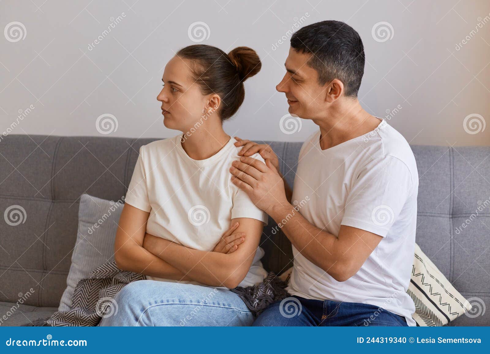 Portrait Of Beautiful Young Couple Is Having A Quarrel While Sitting On