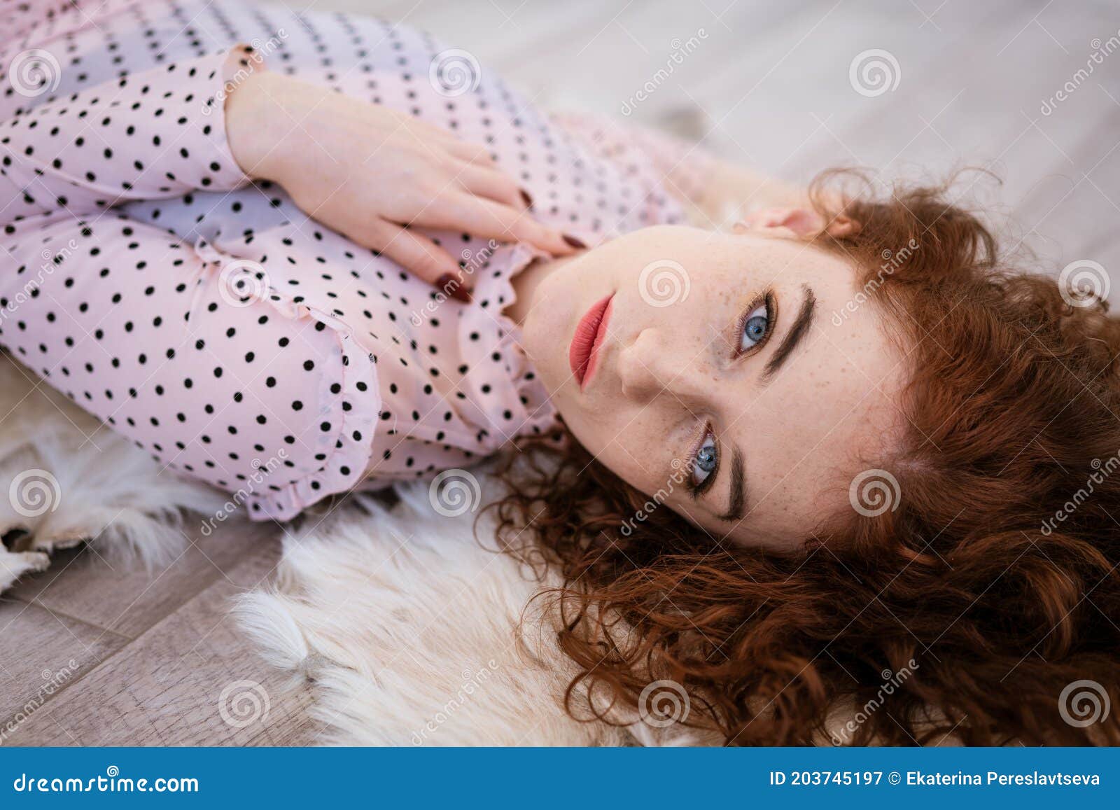 Portrait Of A Beautiful Red Haired Woman Lying On The Floor Stock Image