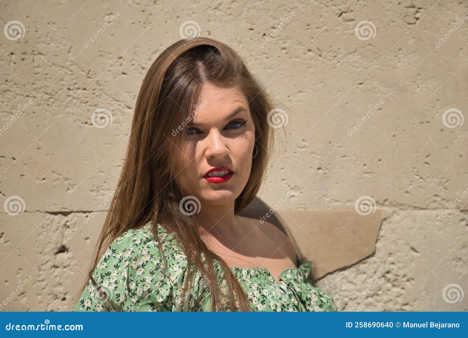 Portrait Of Beautiful Young Woman Blonde Blue Eyes Wearing A Green