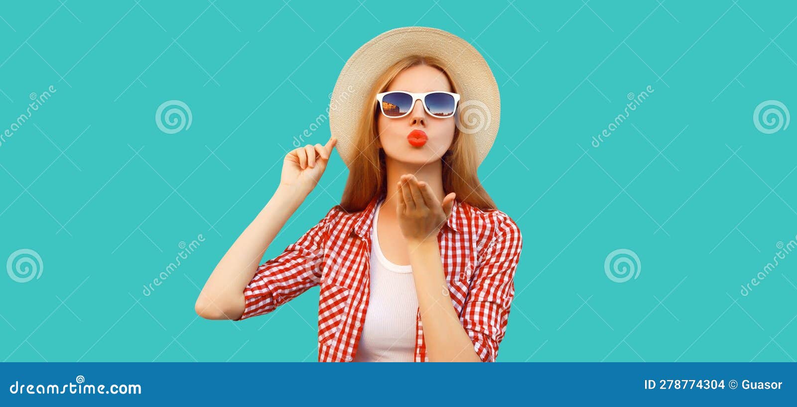 Portrait Of Beautiful Young Woman Blowing Her Lips With Red Lipstick