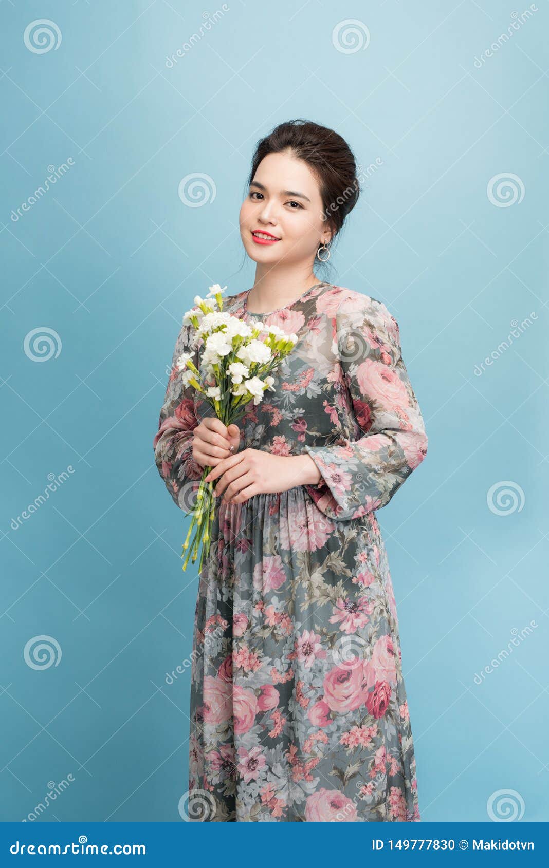 Portrait of a Beautiful Young Woman in Blue Background Stock Photo ...