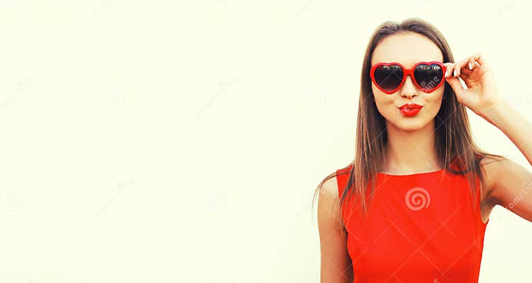 Portrait Of Beautiful Young Woman With Red Lipstick Blowing Her Lips