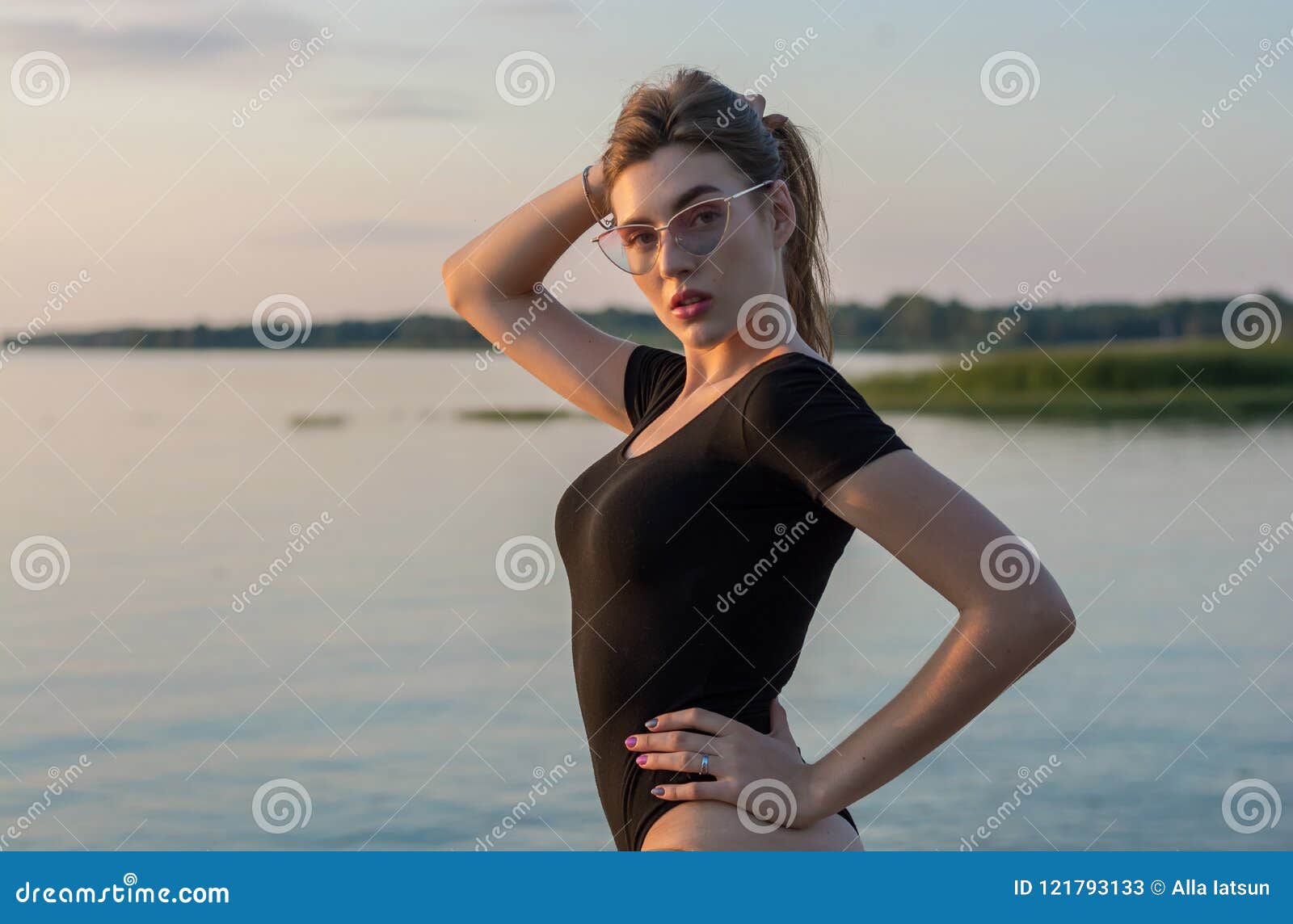 Portrait Of A Beautiful Young Woman In Sunglasses In A Swimsuit Stock