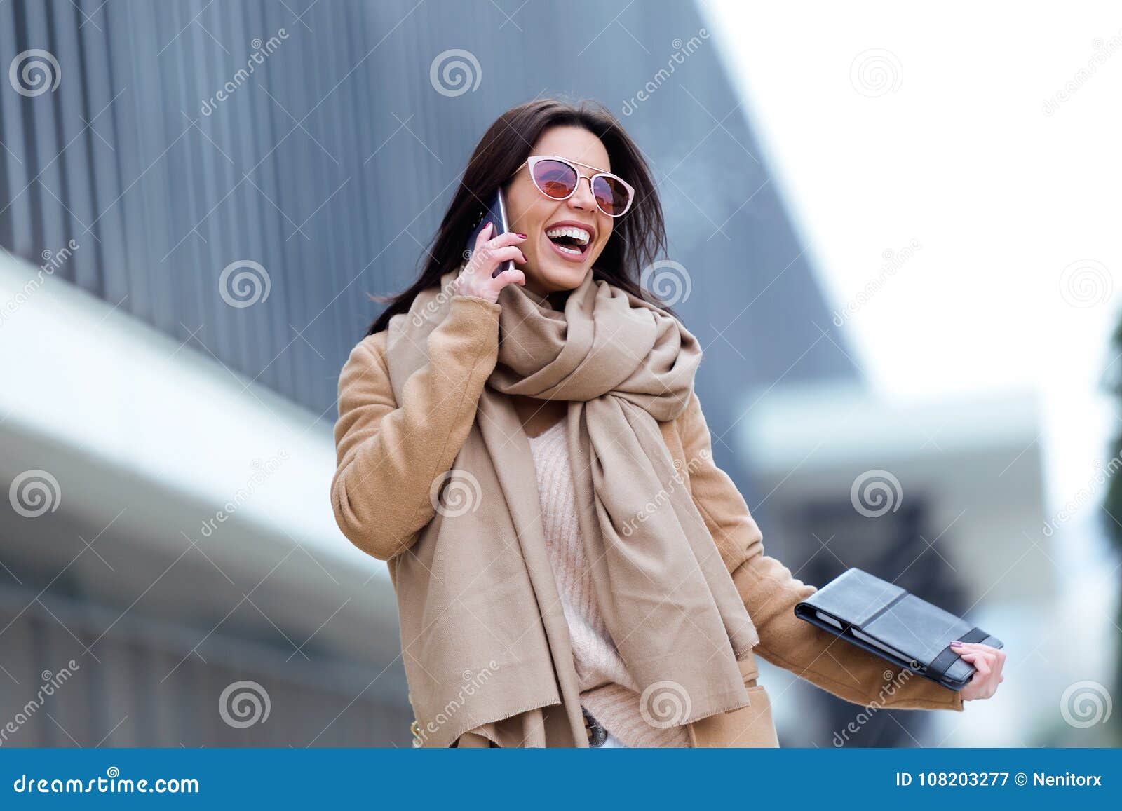 Beautiful Young Woman Using Her Mobile Phone In The Street Stock Image