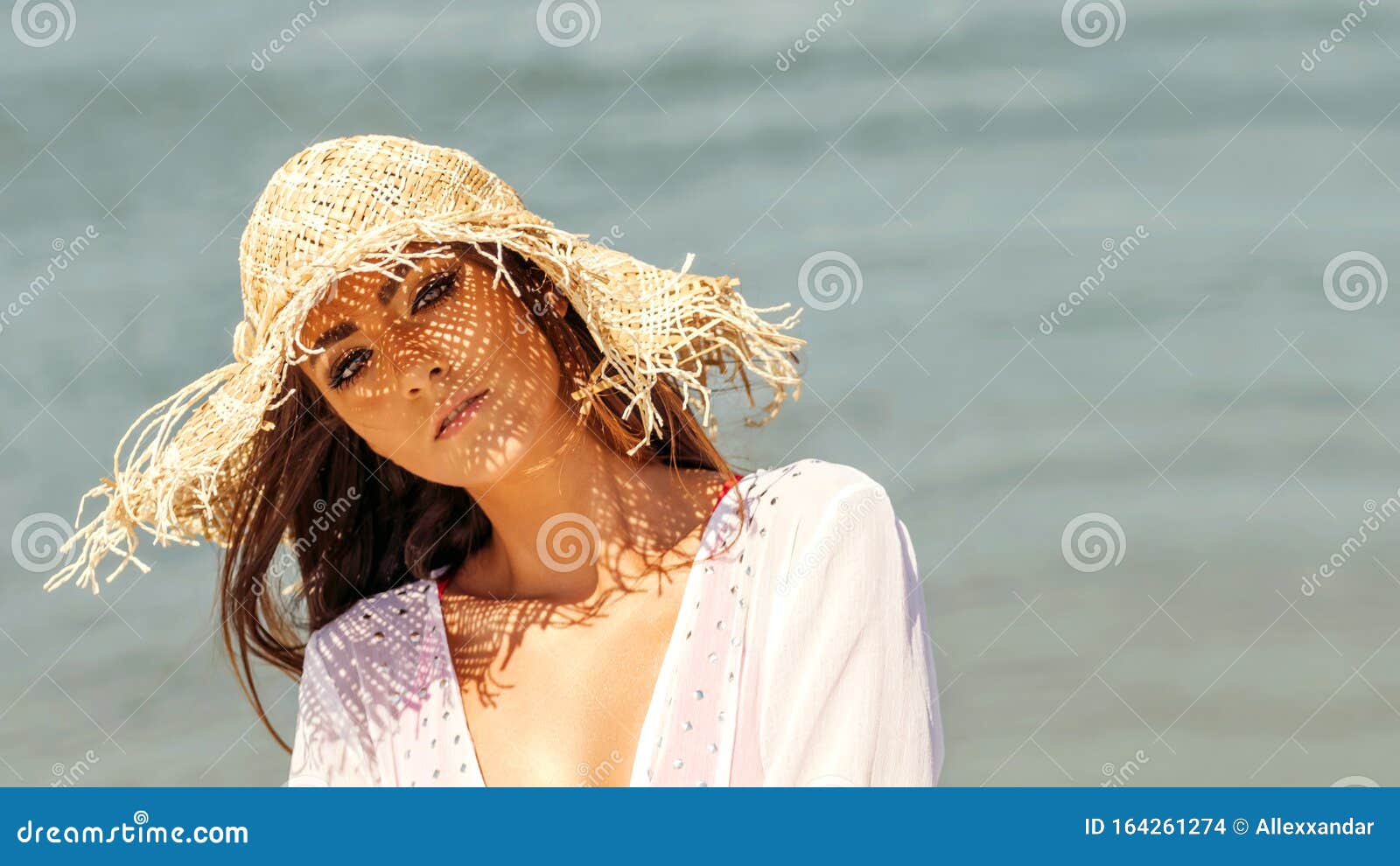 Portrait Of Beautiful Young Woman Wearing Summer Hat At Beach Closeup
