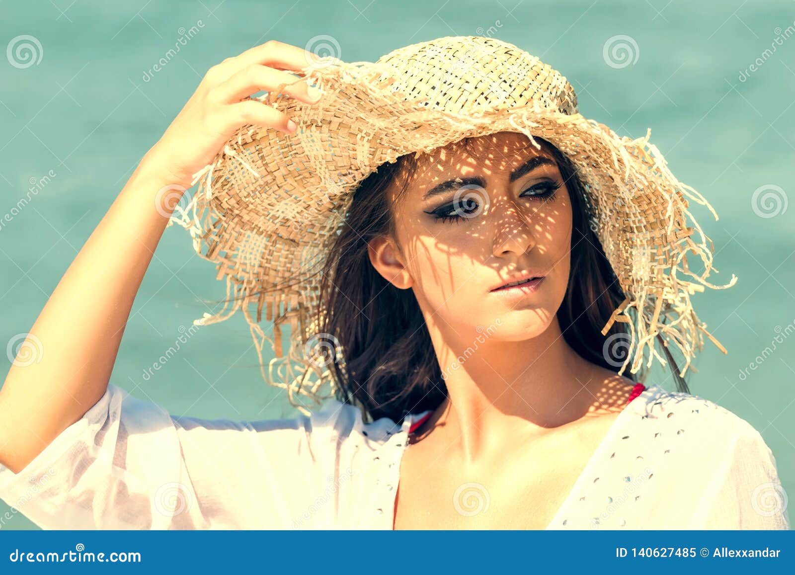 Portrait Of Beautiful Young Woman Wearing Summer Hat At Beach Closeup