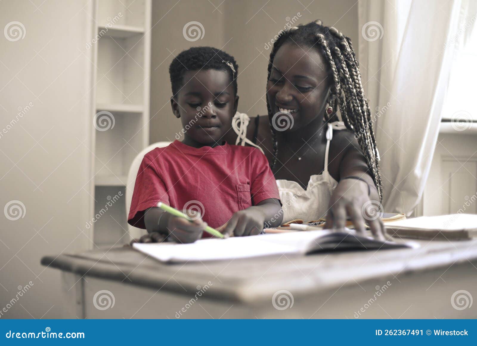 Portrait of a Black Kid Doing His Homework with His Mother in Front of ...