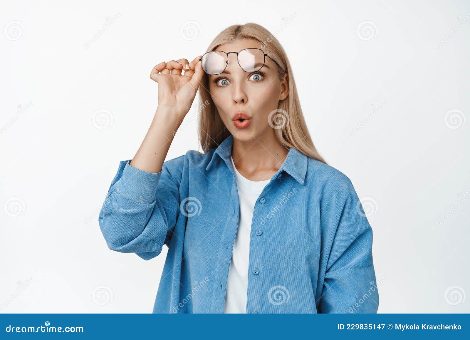 Portrait Of Blond Woman Taking Off Her Glasses Widen Eyes And Staring