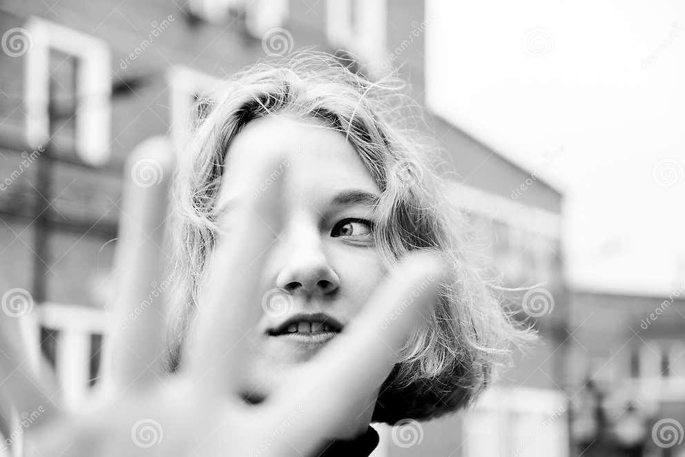 Portrait Of Blonde Kinky Girl Looking Through Her Fingers Stock Image