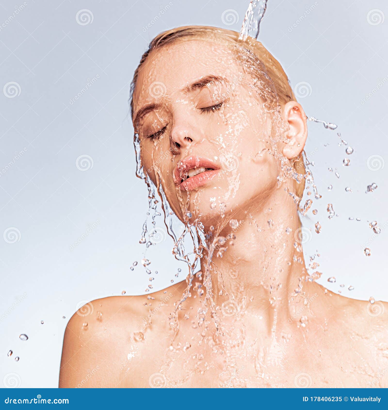 Portrait Of Blonde Woman With Drops Of Water On Her Face Photo Of