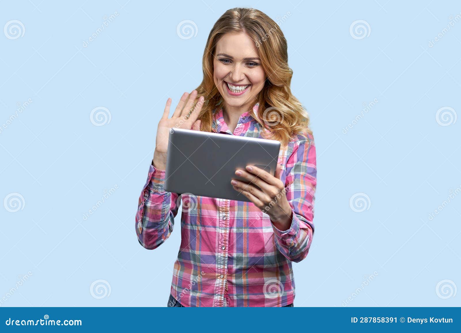 Portrait Of Blonde Woman Waving Her Hand To Someone On Tablet Pc Stock