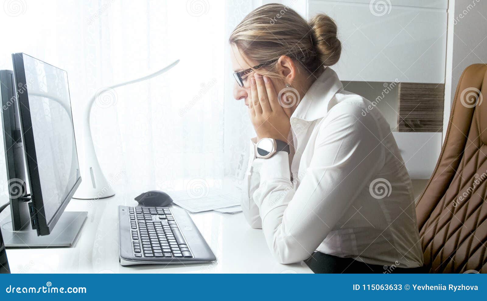 Portrait of Bored Young Woman Sitting in Office and Looking at Computer ...