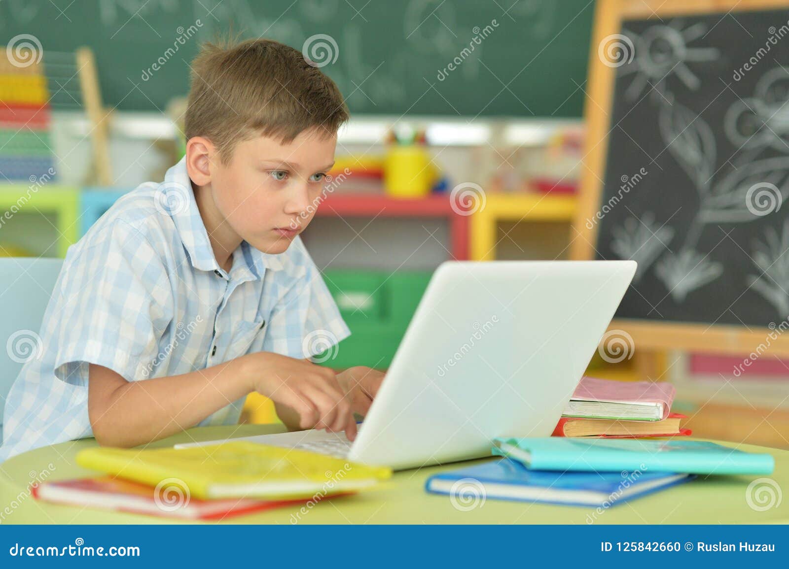 Portrait of Boy Doing Homework in Classroom Stock Photo - Image of ...