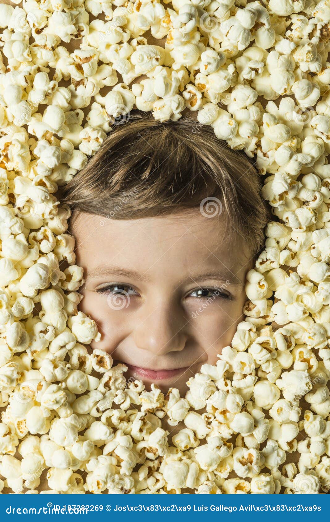 Portrait of a Boy with His Face Surrounded by Popcorn Stock Image ...